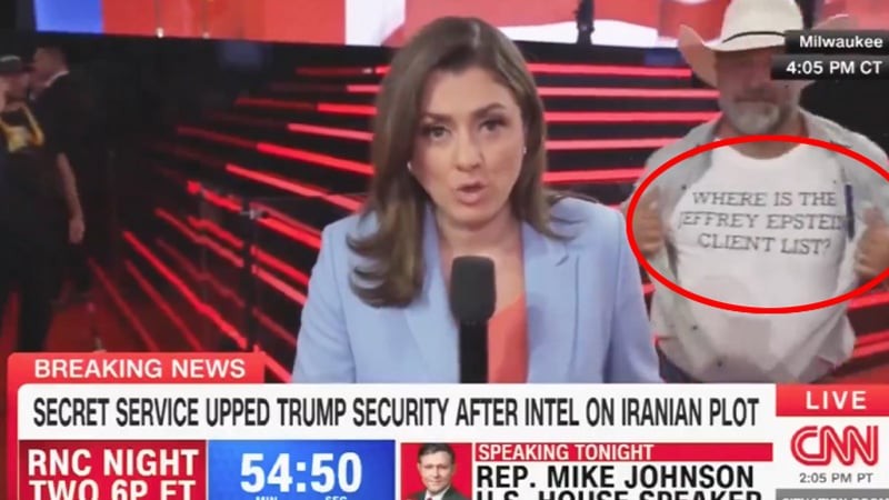 Man Wearing “Where is Epstein Client List?” Shirt Photobombs CNN Live Shot